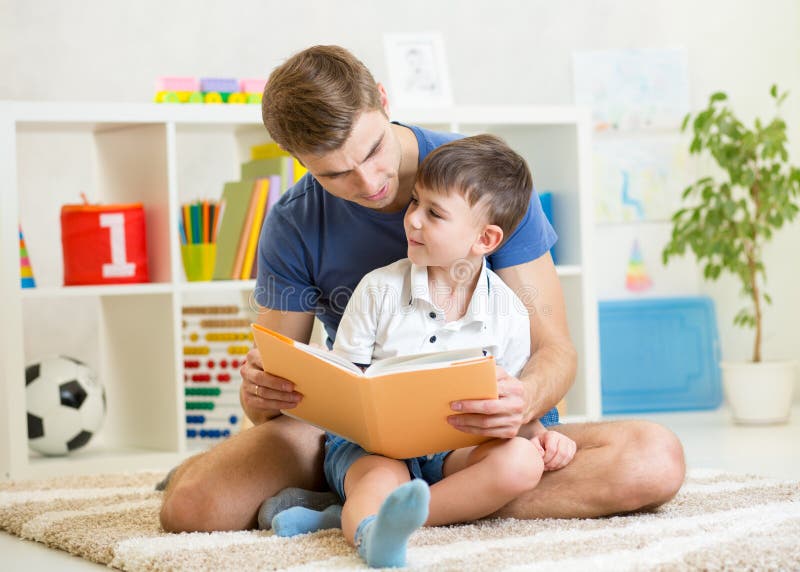 Kid Boy and His Father Read a Book on Floor at Home Stock Photo - Image ...