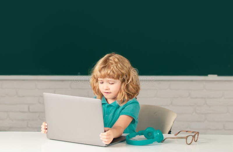 Kid Boy Learning Lesson at School, Making Homework and Using Notebook ...