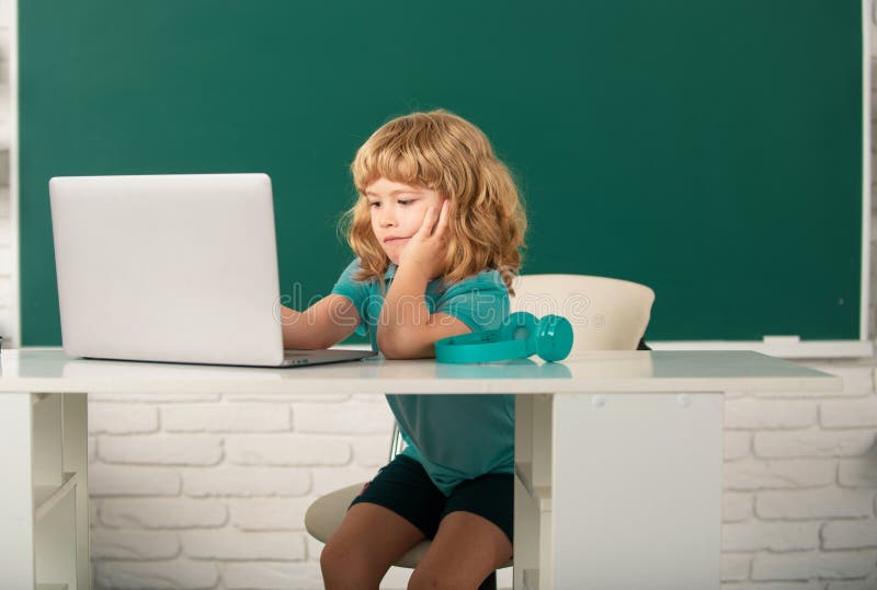 Kid Boy Learning Lesson at School, Making Homework and Using Notebook ...