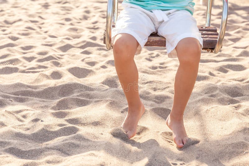 Kid boy legs on a swing stock photo. Image of childhood - 88300894