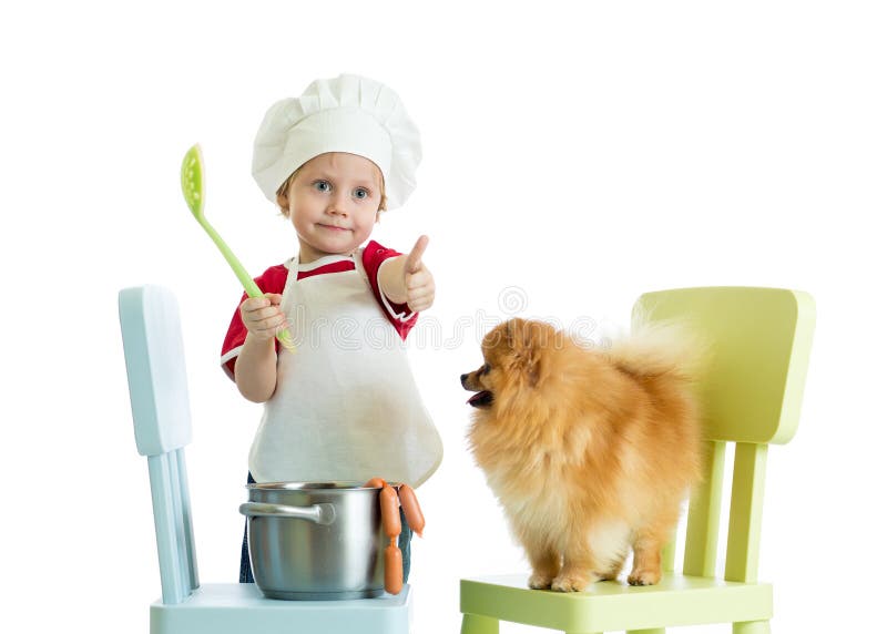 Kid Boy Playing Chef with Dog. Child Weared Cook Feeds Spitz Puppy ...