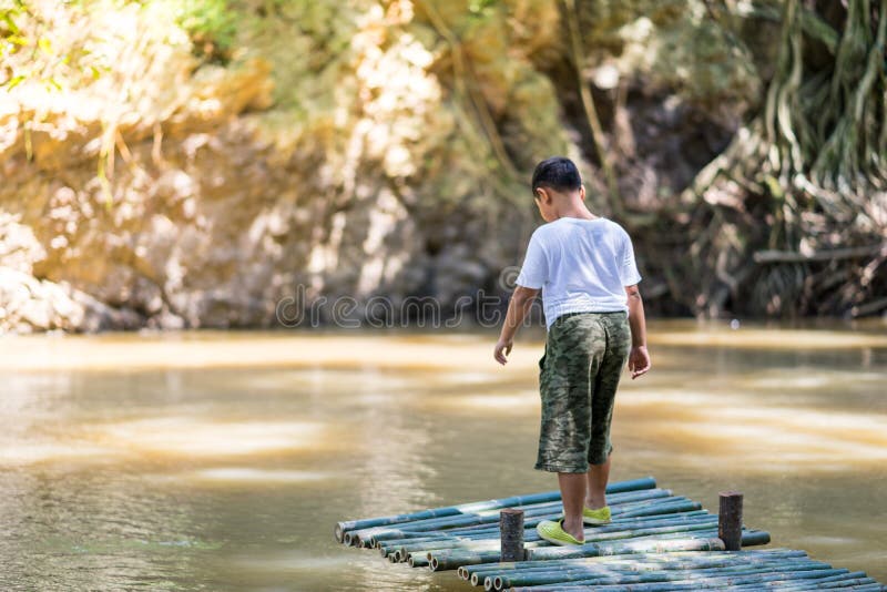 Kid Boy Stand on the Bamboo Bridge beside the Lake Stock Photo - Image ...