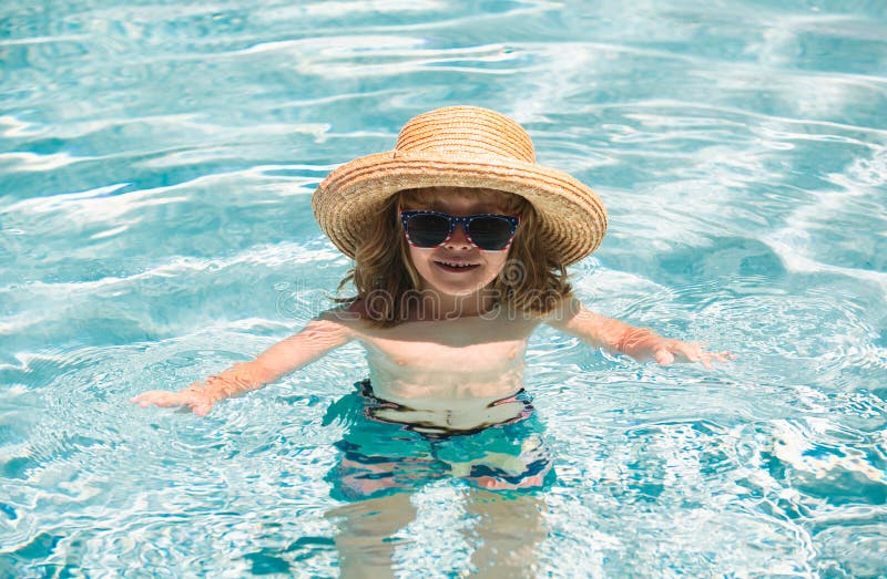 Kid Boy Swim in Swimming Pool. Cute Boy in the Water Playing with Water ...