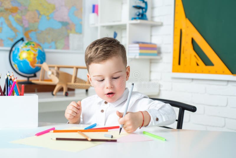 Kid Boy Writing in Classroom. Child of Primary School. Stock Image ...