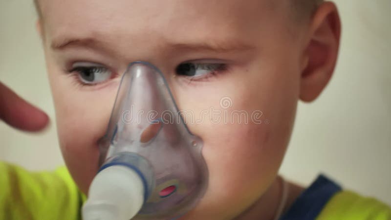 The Kid Breathes in a Mask with an Inhaler. Stock Video - Video of ...