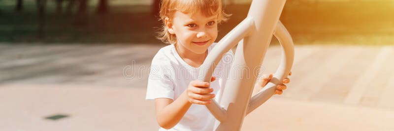 Kid on City Playground Swings on Swing Carousel. Cute Little Happy ... Kid on City Playground Swings on Swing Carousel. Cute Little Happy ...