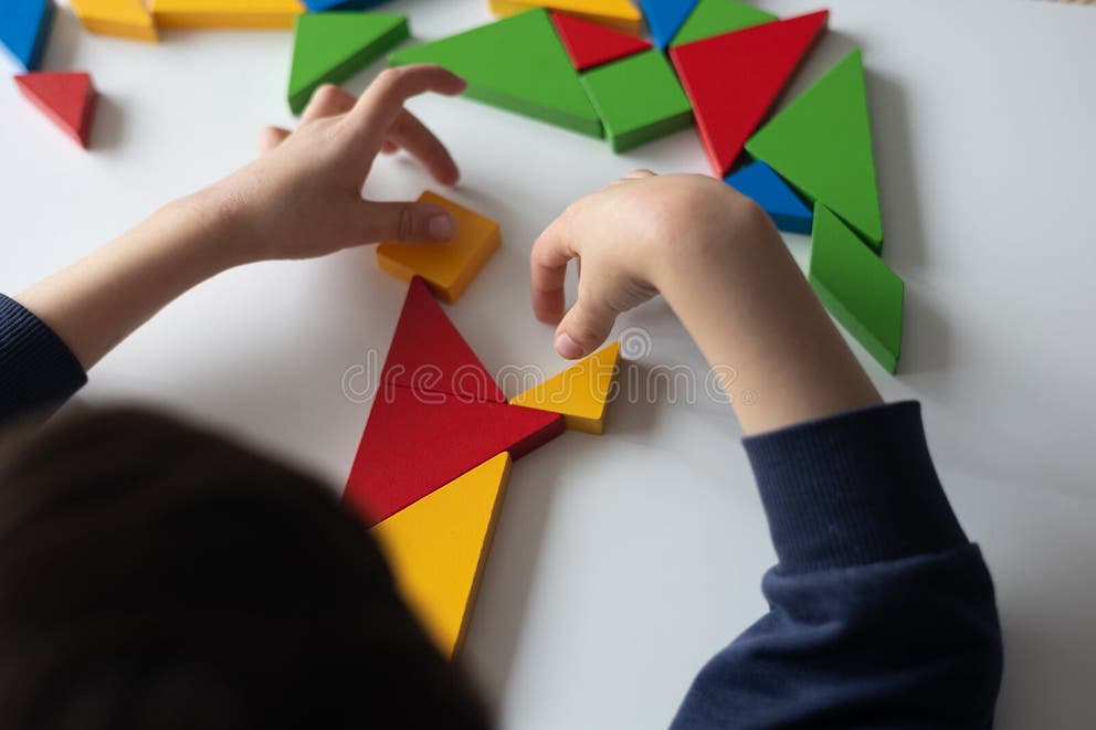 Kid Composing a Puzzle with Colorful Wooden Geometric Shapes ...