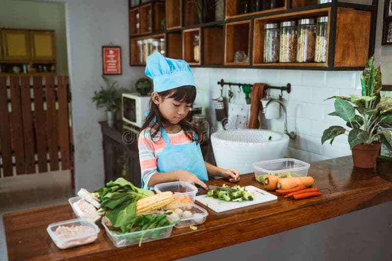 Kid cooking in the kitchen stock image. Image of healthy - 182934207