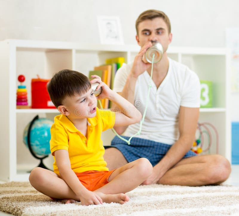 Kid and Dad Having a Phone Call with Tin Cans Stock Photo - Image of ...