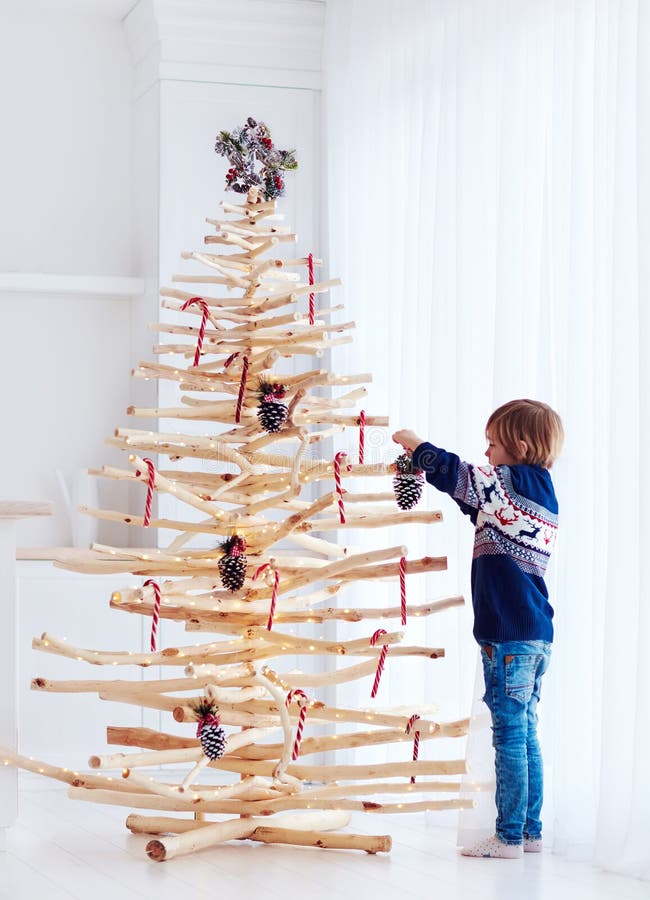 Kid Decorating the Eco Friendly, Reusable Christmas Tree, with Pine ...