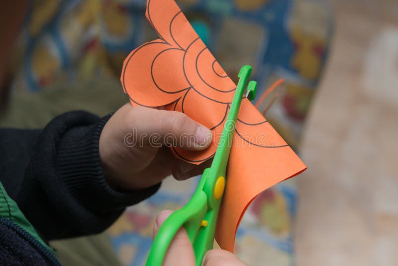 Kid doing paper cutting stock photo. Image of handmade - 89534238
