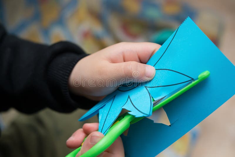 Kid doing paper cutting stock photo. Image of action - 91105846