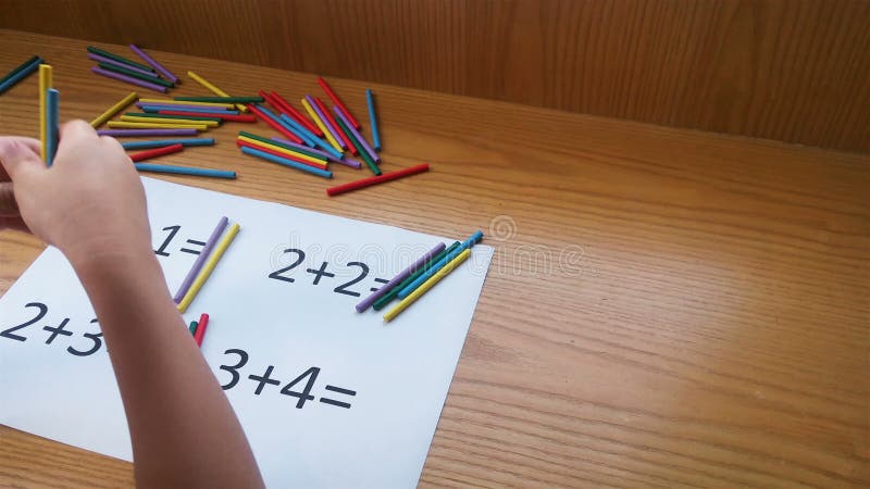 Kid Doing Simple Additions by Counting Numbers of Sticks Stock Video ...