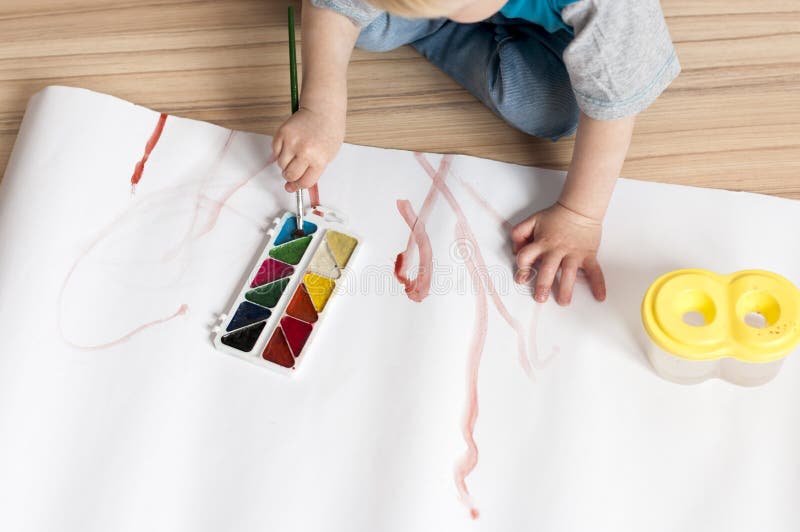 The Kid Draws a Line with Watercolor Paints on White Paper Stock Photo ...
