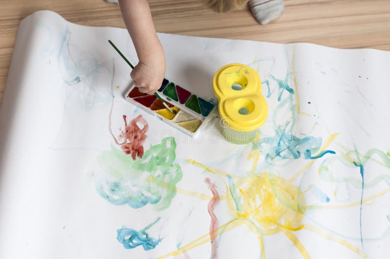 The Kid Draws a Line with Watercolor Paints on White Paper Stock Photo ...