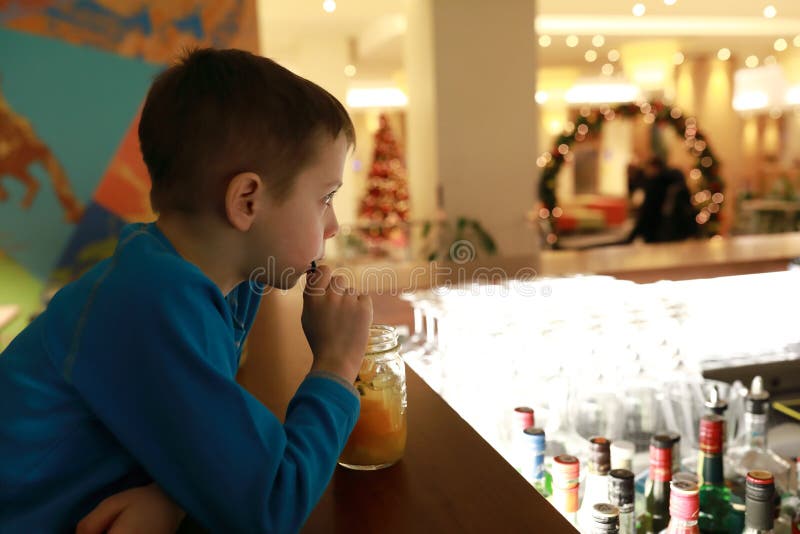 Kid Drinking Lemonade with Ice at Bar Stock Photo - Image of fruit ...