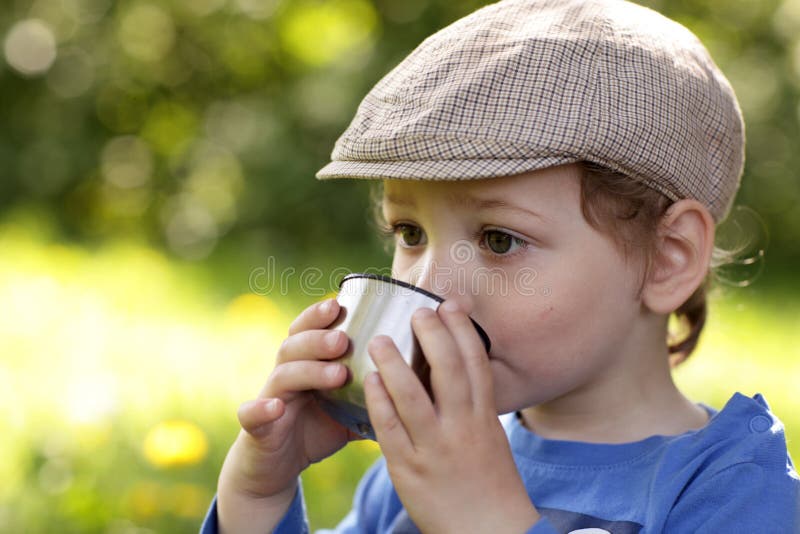 Kid drinking tea outdoor stock image. Image of dishware - 42440177
