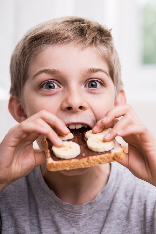 Kid eating with appetite stock photo. Image of mouth - 61872782