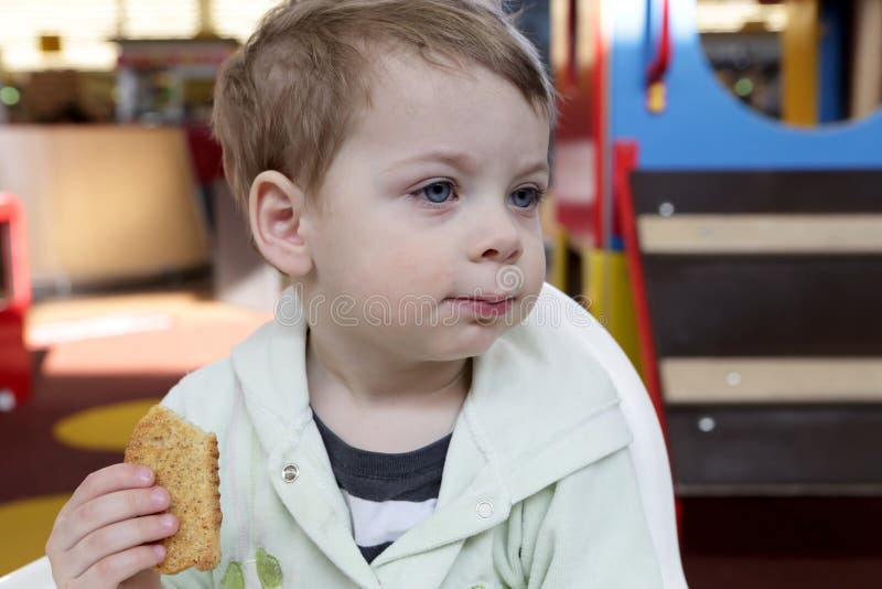Kid eating biscuit stock image. Image of cute, adorable - 95715975