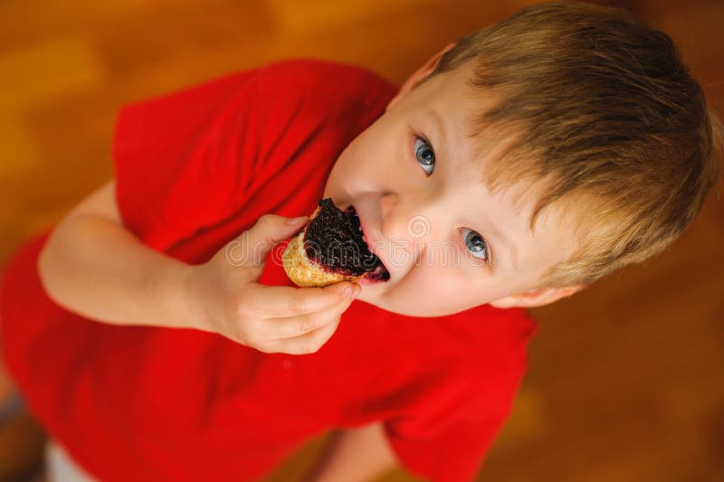 Kid Eating Bread with Bilberry Jam Stock Image - Image of hold, chew ...