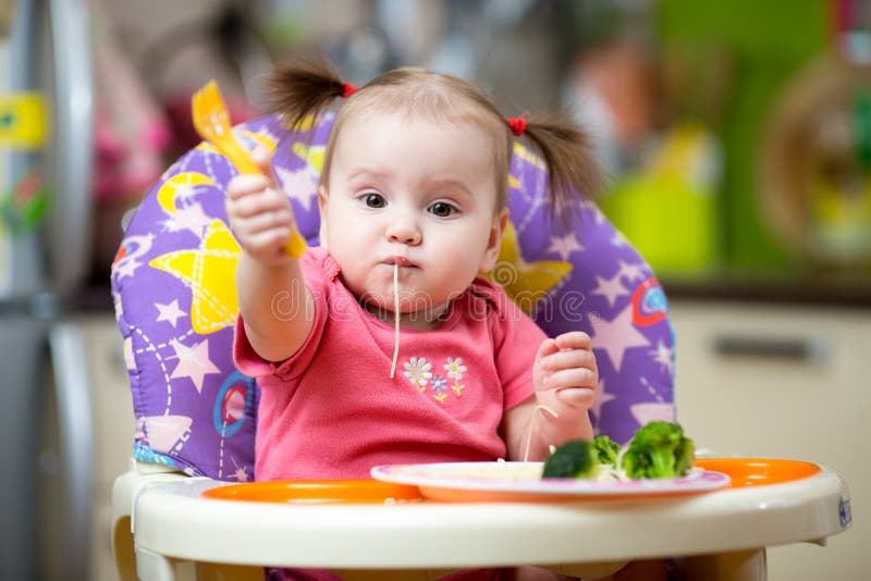 Kid eating food on kitchen stock image. Image of cabbage - 50589985