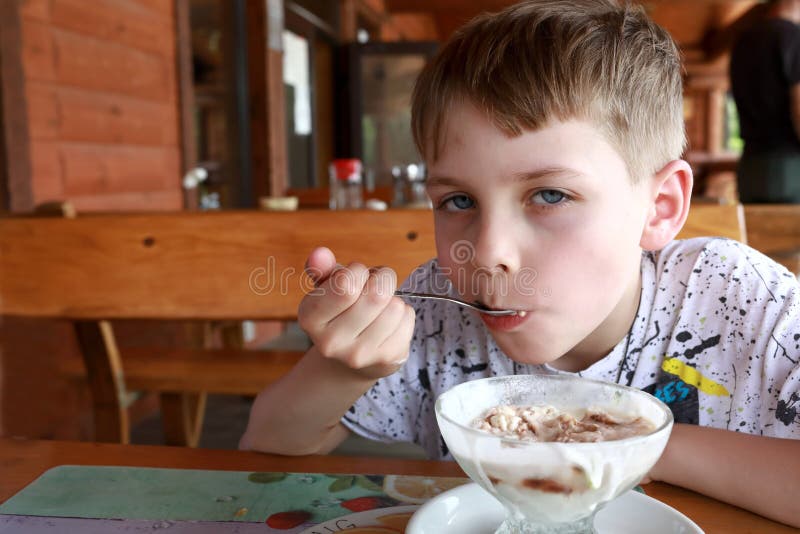 Kid Eating Ice-cream at Table Stock Photo - Image of person, holding ...