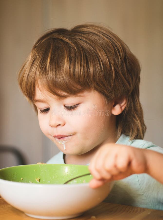 Kid Eating. Little Boy Having Breakfast in the Kitchen. Stock Photo ...