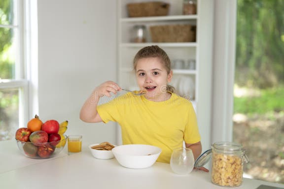 Kid Eating Lunch in White Kitchen. Cute Kid Eating Dinner in Kitchen ...