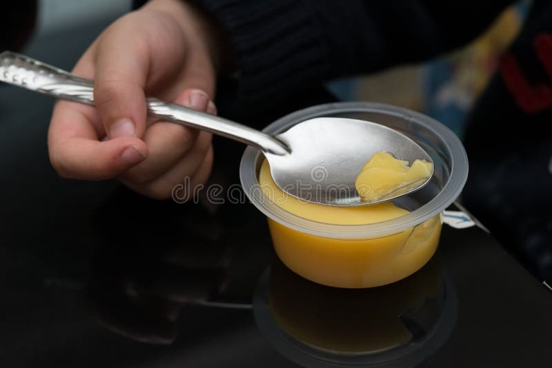 Kid eating mango pudding stock photo. Image of flavor - 89534428