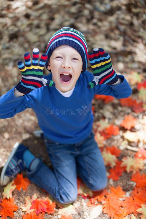 Child Laying on Autumn Leafs Stock Image - Image of gazing, looking ...