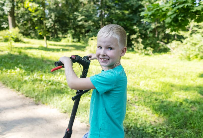 Kid Fall when Riding an Electric Scooter. Riding an E-scooter without ...