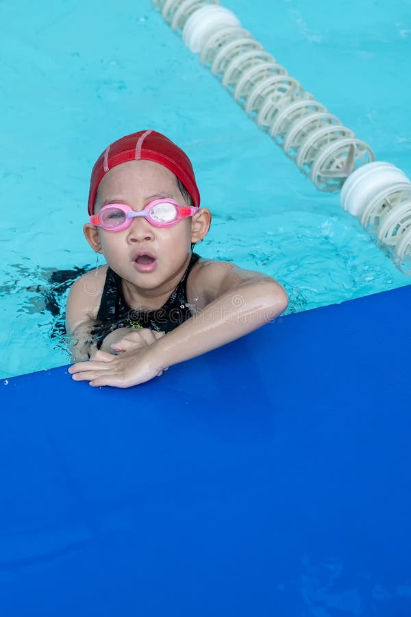 A Kid Feels Tired in Swimming Class in the Swimming Pool Stock Photo ...