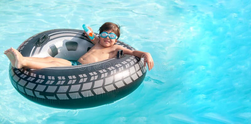A Kid Floats on a Float in a Swimming Pool. Concept of Fun and Play ...