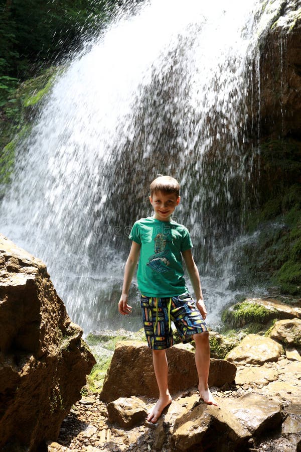 Kid in Front of Waterfall Shum on Rufabgo Stream Stock Image - Image of ...
