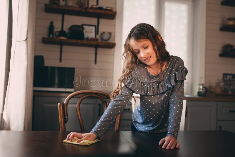 Kid Girl Helping with Housework and Cleaning Table in the Kitchen Stock ...