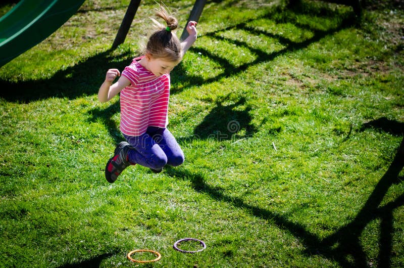 Kid Girl Jumping on Green Grass in Children`s Park Stock Image - Image ...