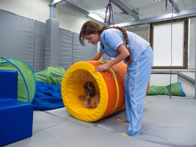 Child with Physiotherapist on Swing during Sensory Integration Session ...