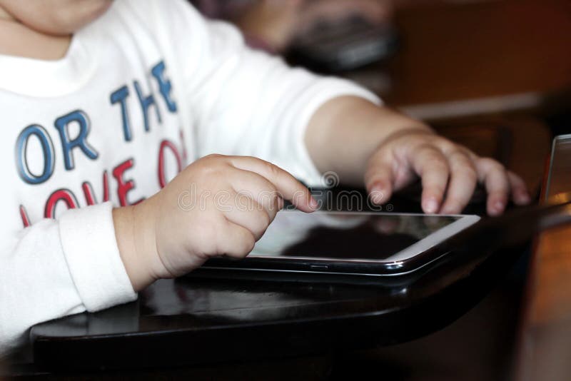 Kid hand play smart phone stock photo. Image of home - 50567926