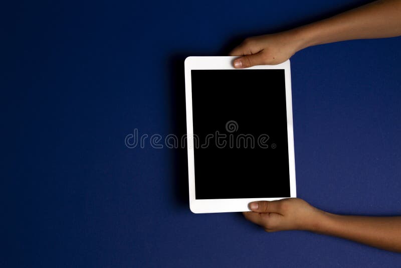 Kid Hands Holding White Tablet Computer on Navy Blue Background Stock ...