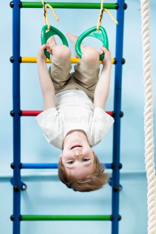Kid Hanging on Gymnastic Rings Stock Image - Image of face, happiness ...
