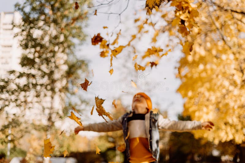 Kid Having Fun in Autumn Park with Fallen Leaves, Throwing Up Leaf ...
