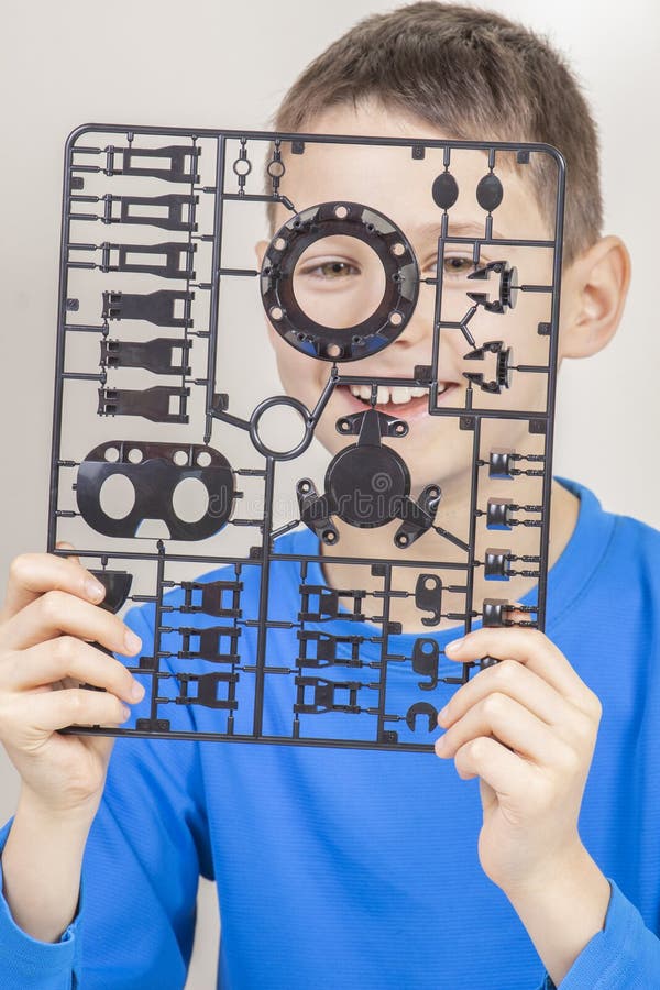Kid Having Fun while Making Robot at Home. Smiling Boy with Details of ...