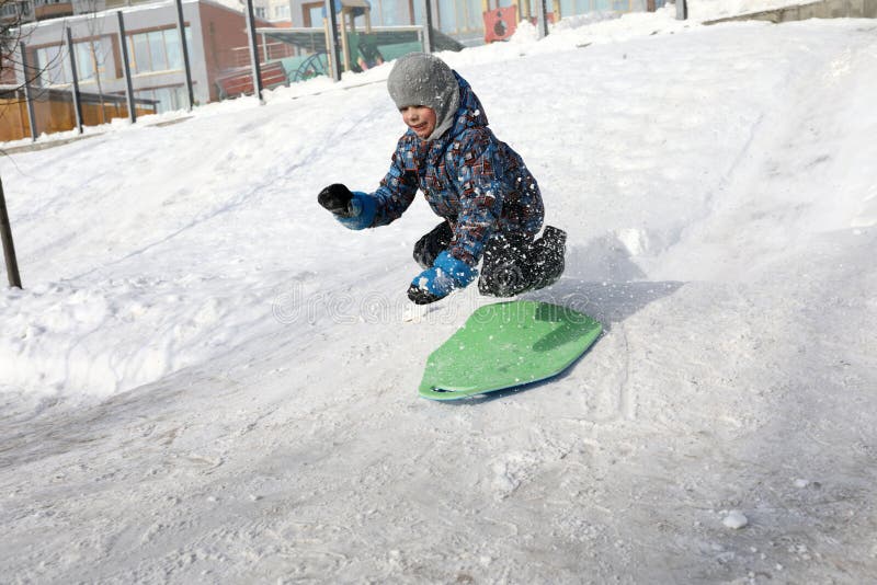 Kid having fun on sled stock photo. Image of holiday - 111257912