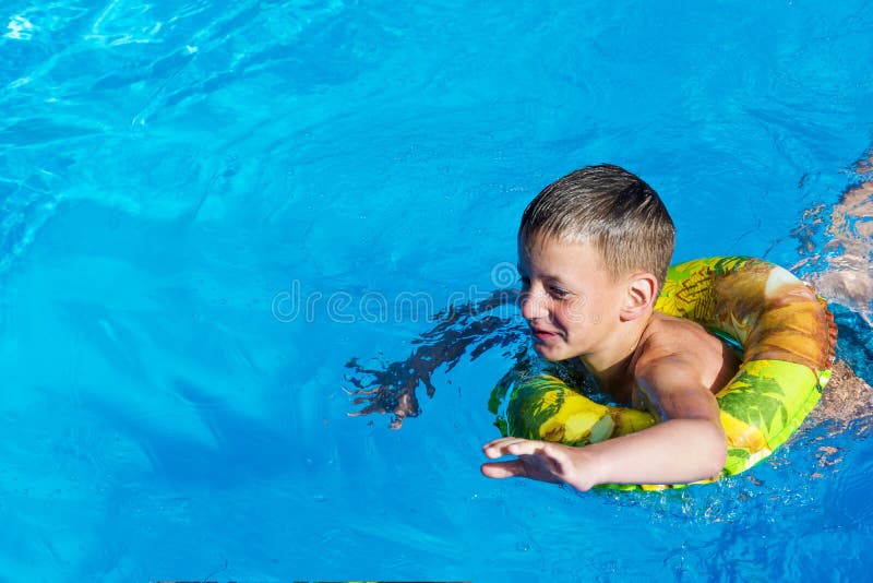 Kid Having Fun in the Swimming Pool on Inflatable Ring. Summer Vacation ...