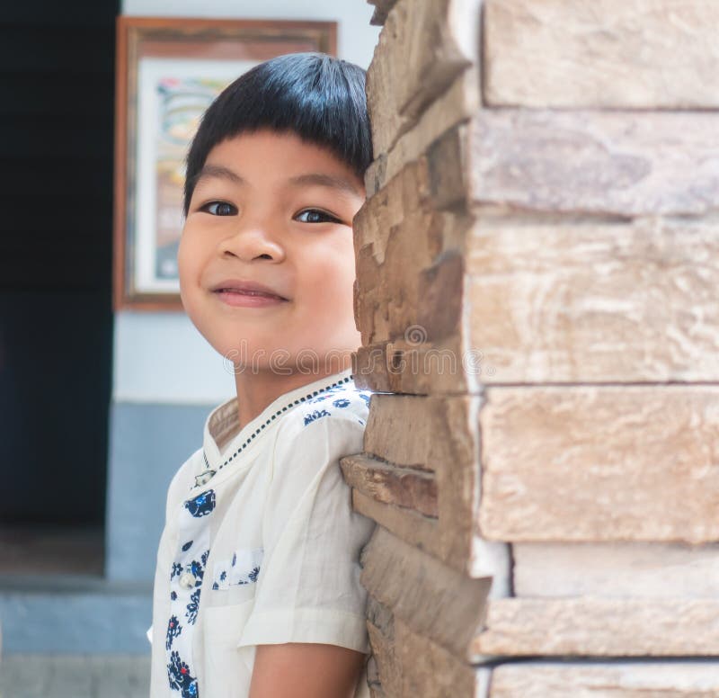 Kid Hiding Behind the Stone Pole Stock Photo - Image of hiding, playing ...