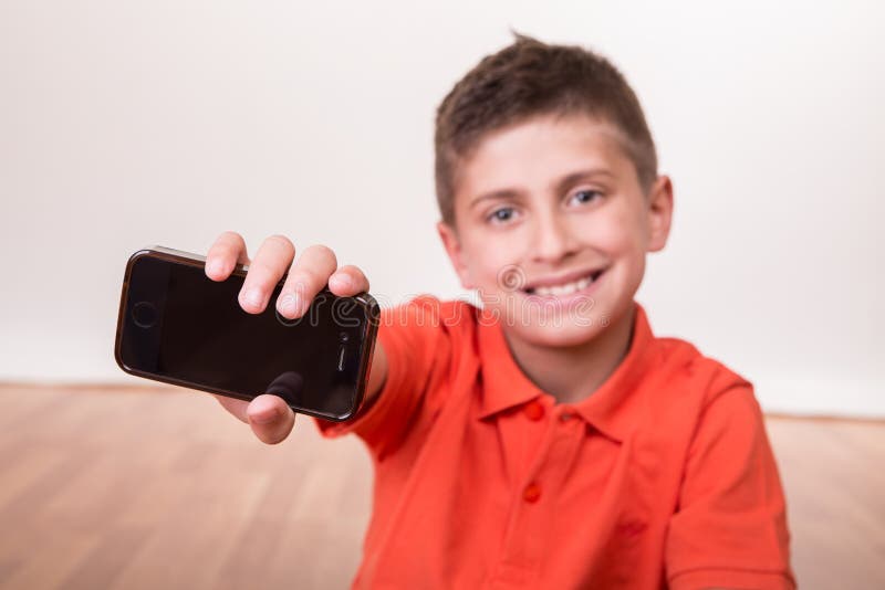 Kid holding smartphone stock photo. Image of happy, cute - 44441730