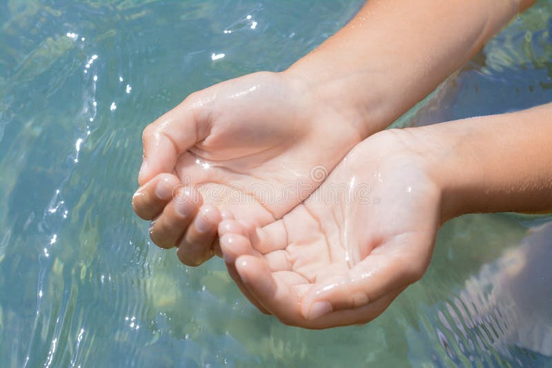 Kid Holding Water in Hands Above Sea Outdoors, Closeup Stock Image ...