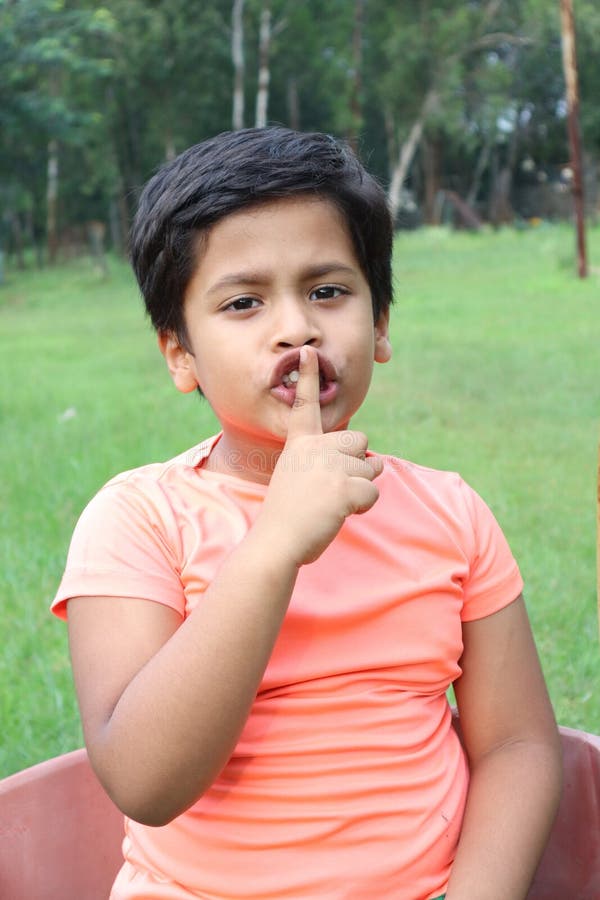A Kid with a Finger on Lips Stock Photo - Image of beautiful, beauty ...