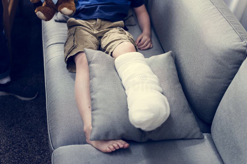 Kid with Injured Leg is Sitting on the Couch Stock Image - Image of ...
