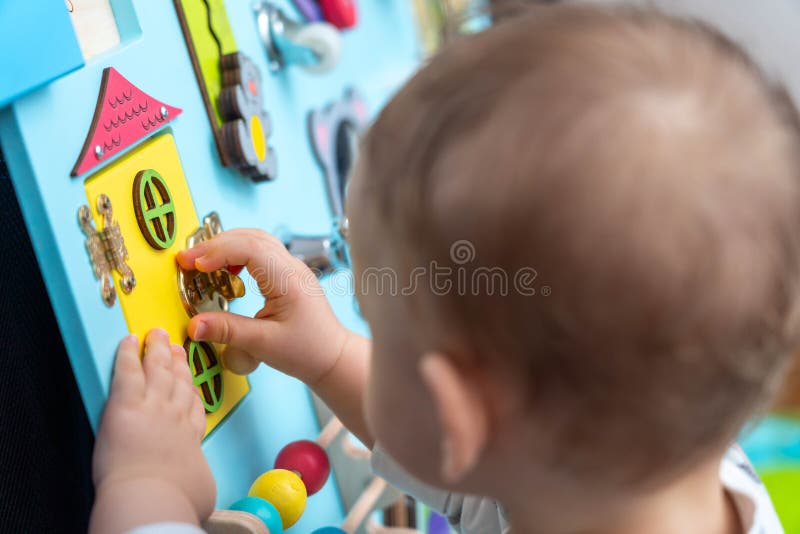 The Kid is Intently Trying To Open the Lock on the Game Board Stock ...